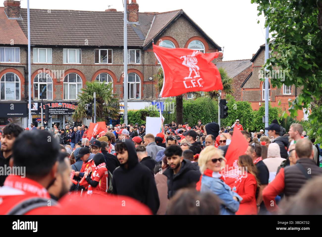 A crowd of Liverpool fans waving a red flag at Allerton Maze on Queens ...