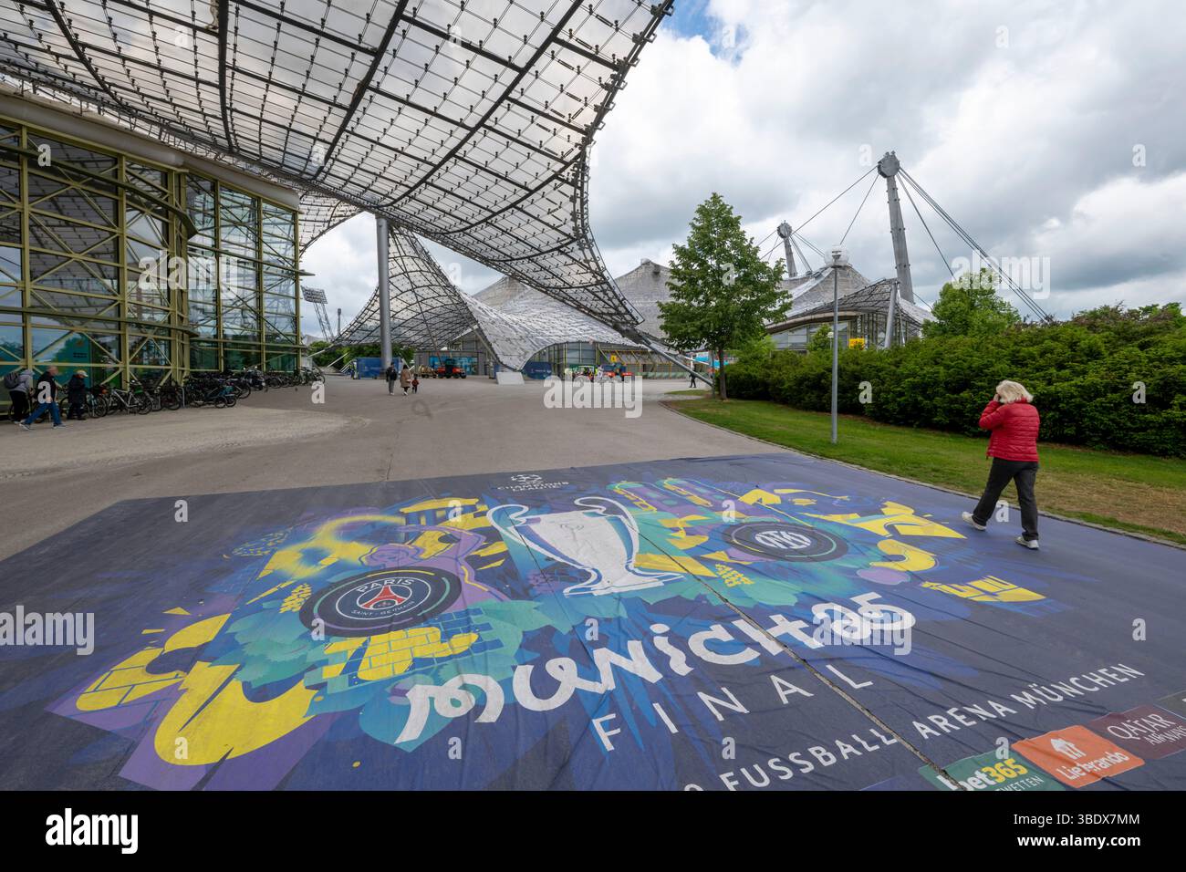 Munich, Germany. 26th May, 2025. A visitor to the Olympic Park walks ...