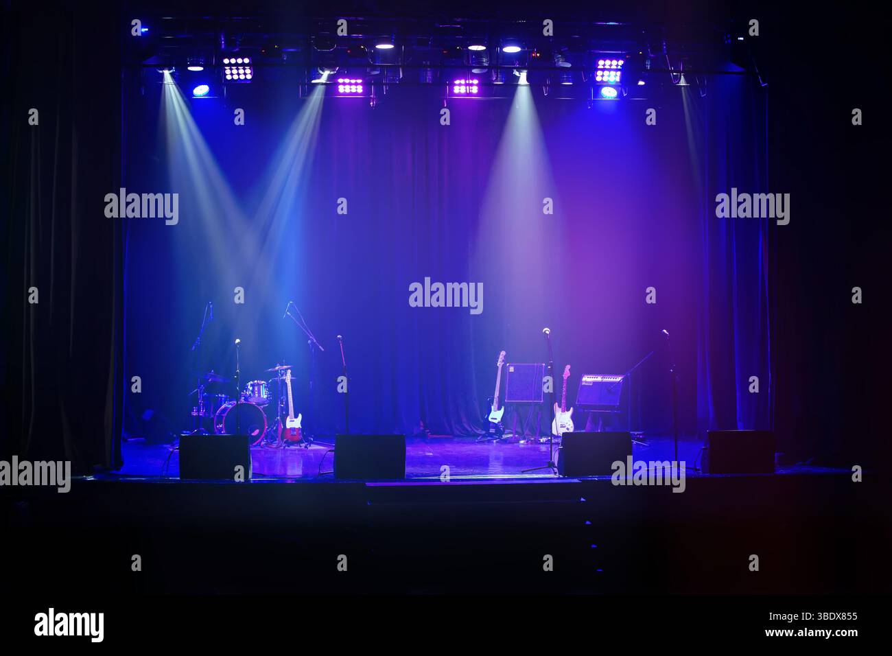 Dark background of the stage with musical instruments illuminated by a ...