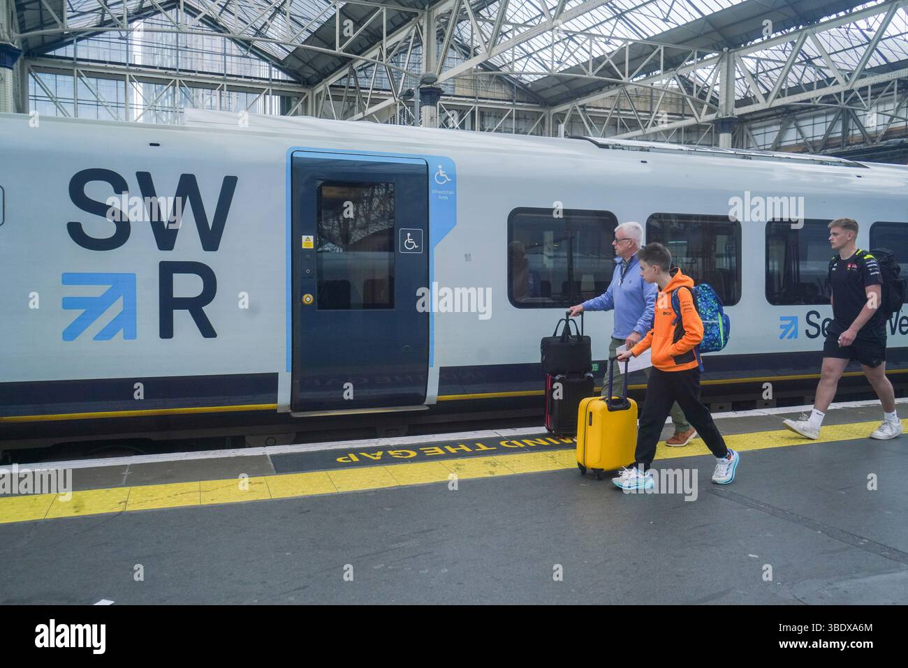 London, UK. 26 May 2025. Passengers boarding a South Western train at ...