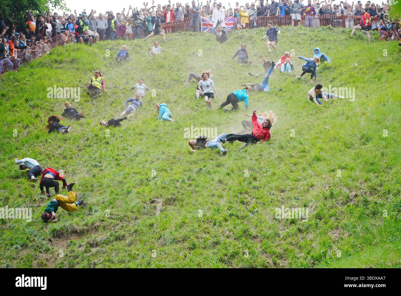 Participants take part in the women's race during annual cheese rolling ...
