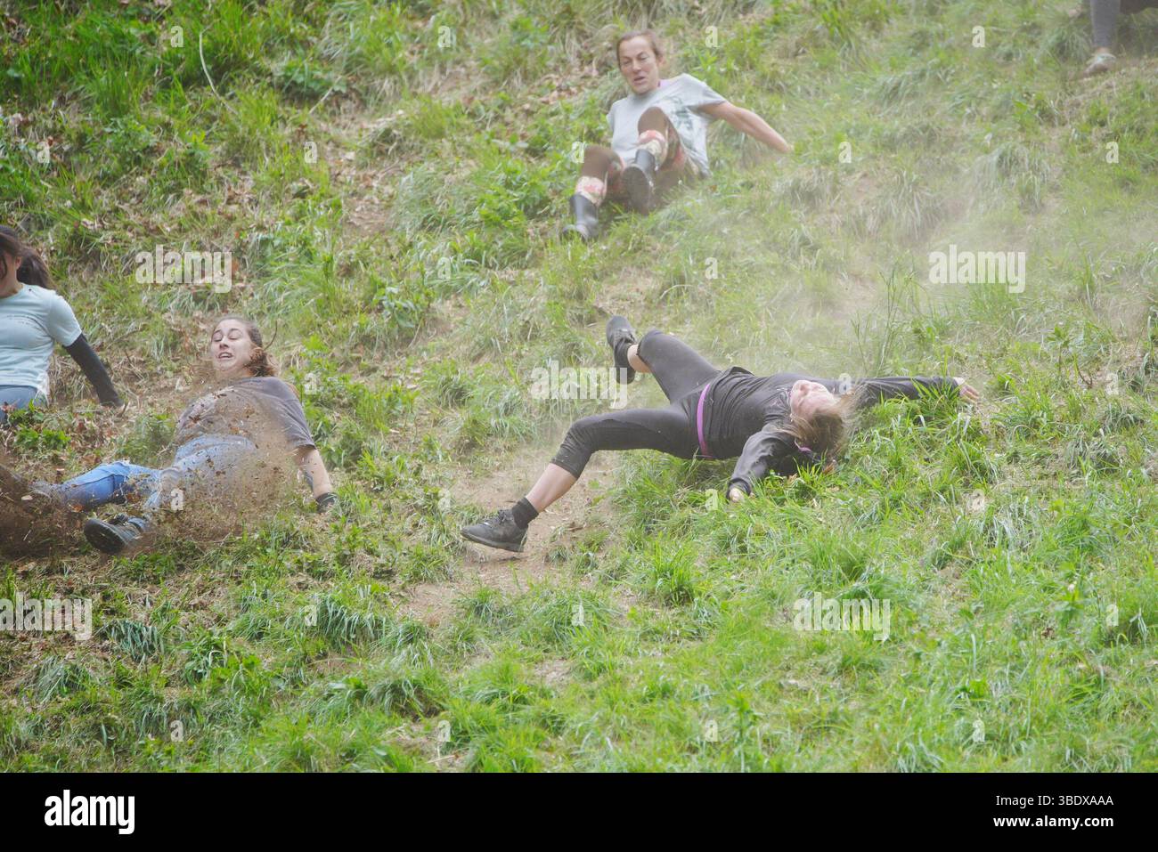 Participants take part in the women's race during annual cheese rolling ...