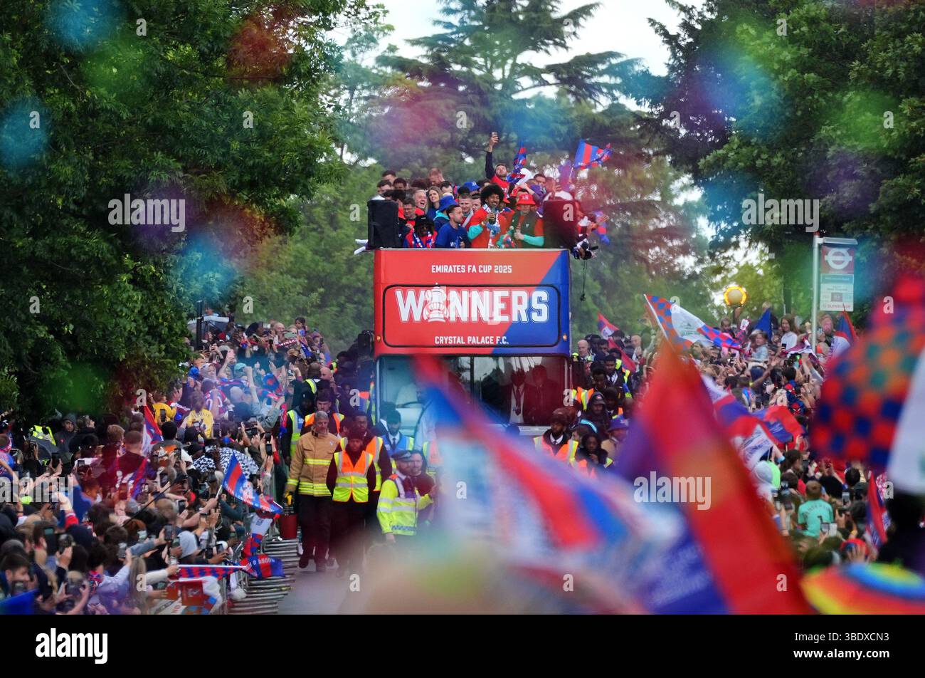 Crystal Palace players on a open-top bus pass by fans during the FA Cup winners parade in London ...
