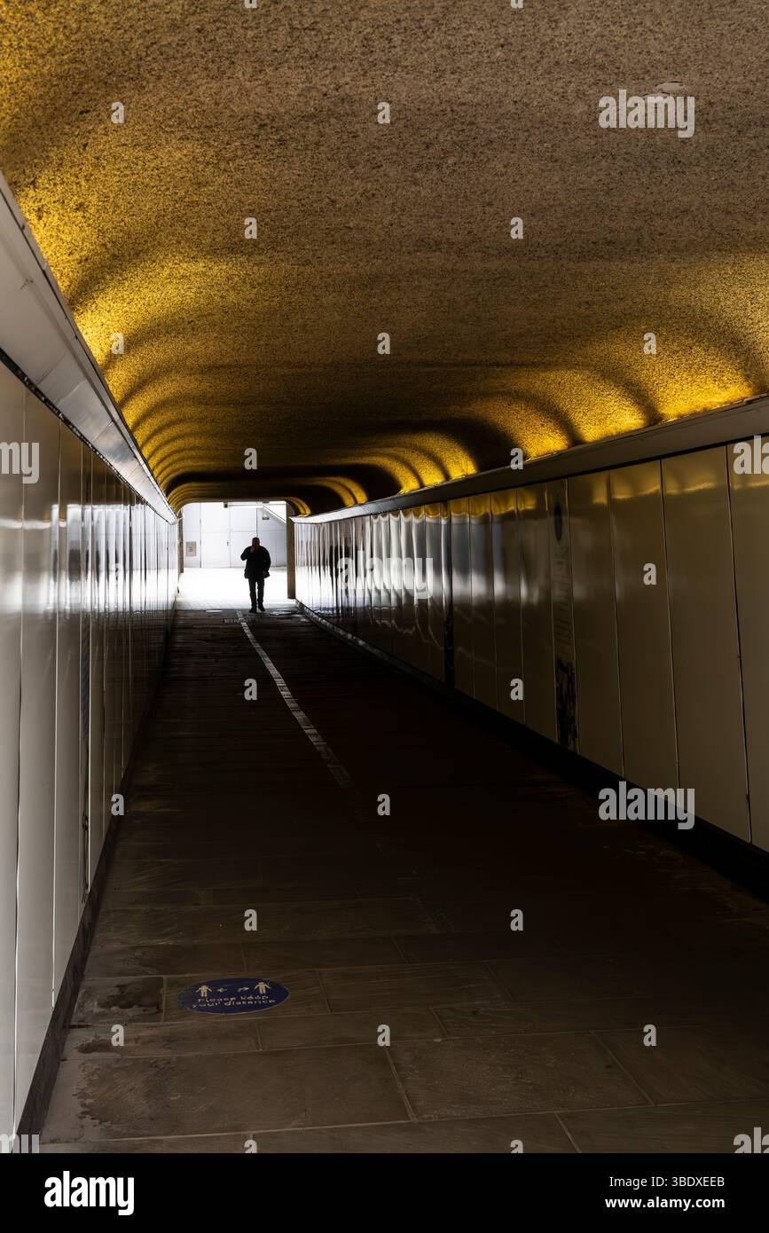 The silhouette of a person walking through an underpass at Tower Hill ...