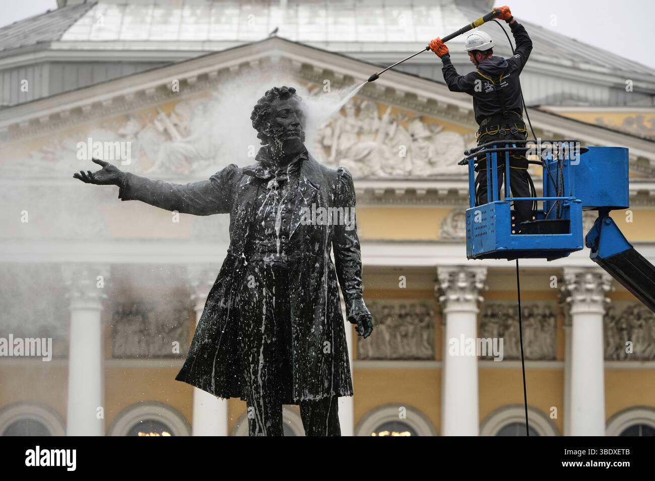 A worker cleans a statue of famous Russian poet Aleksander Pushkin in ...