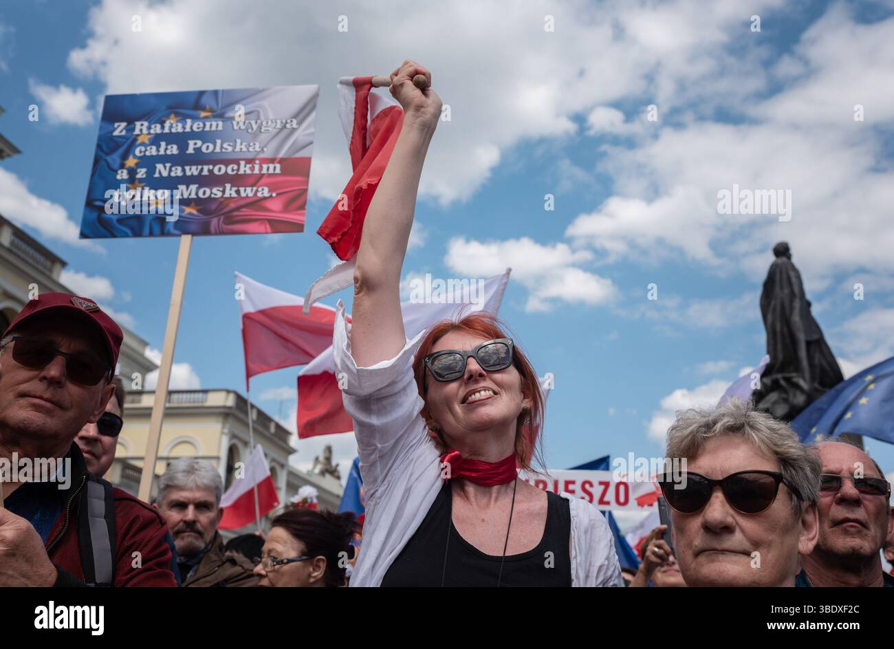 Warsaw, Poland. 25th May, 2025. A woman holds a white and red flag ...