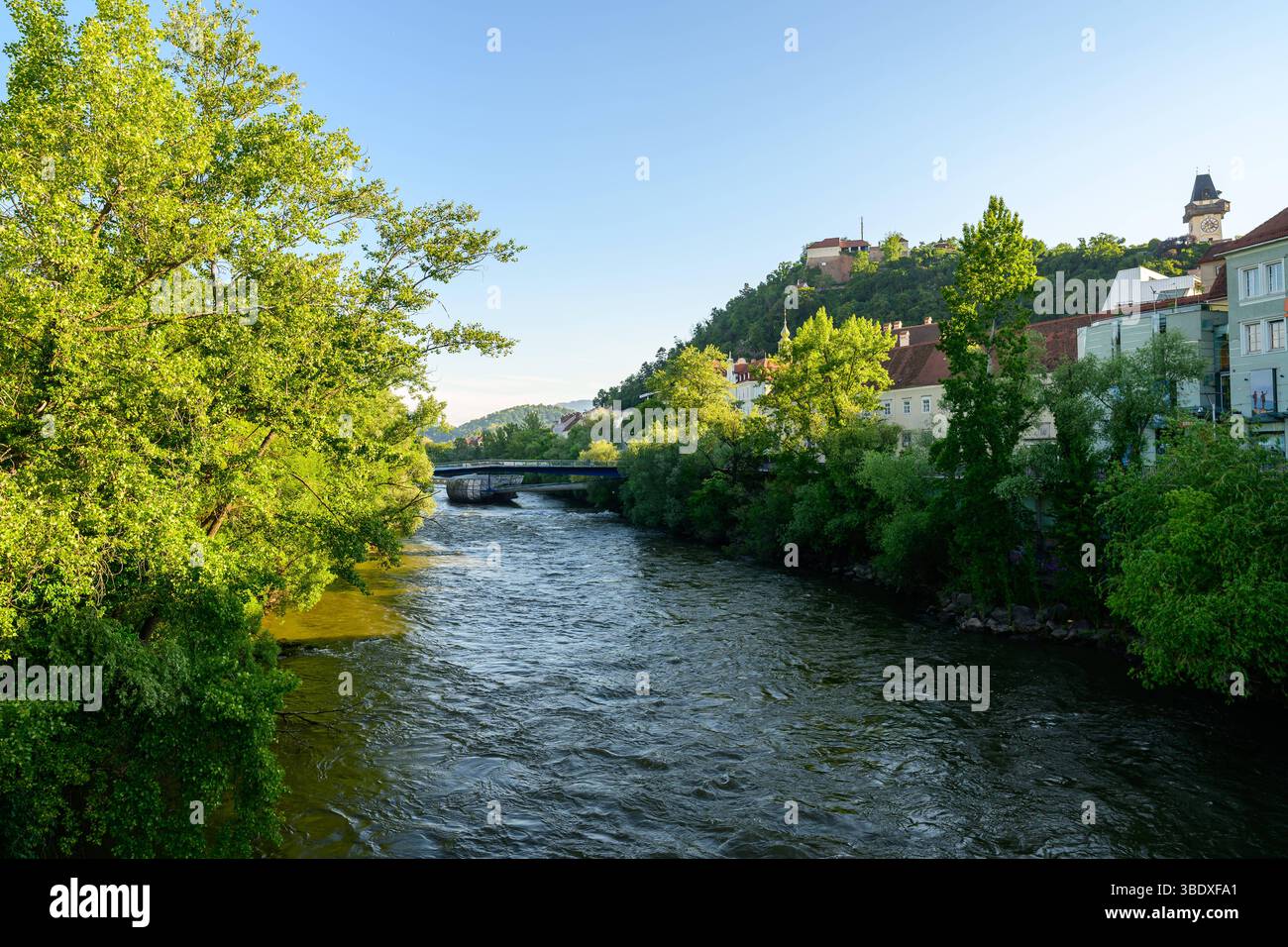 graz, austria, 24 may 2025, river mur with a view to the clocktower ...