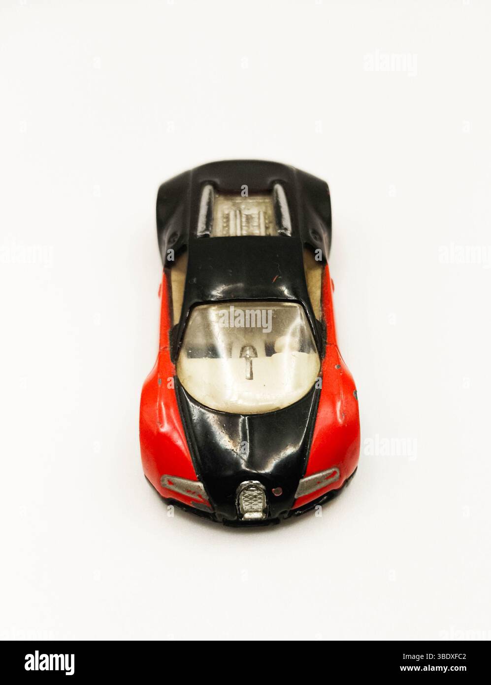 A classic miniature toy car in red and black, capturing the essence of ...