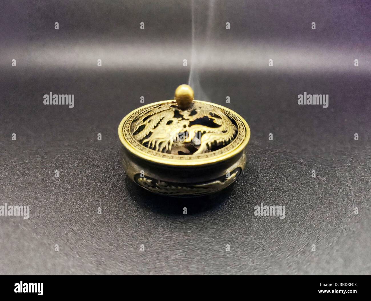 An elegant decorative incense burner made of metal, featuring intricate ...