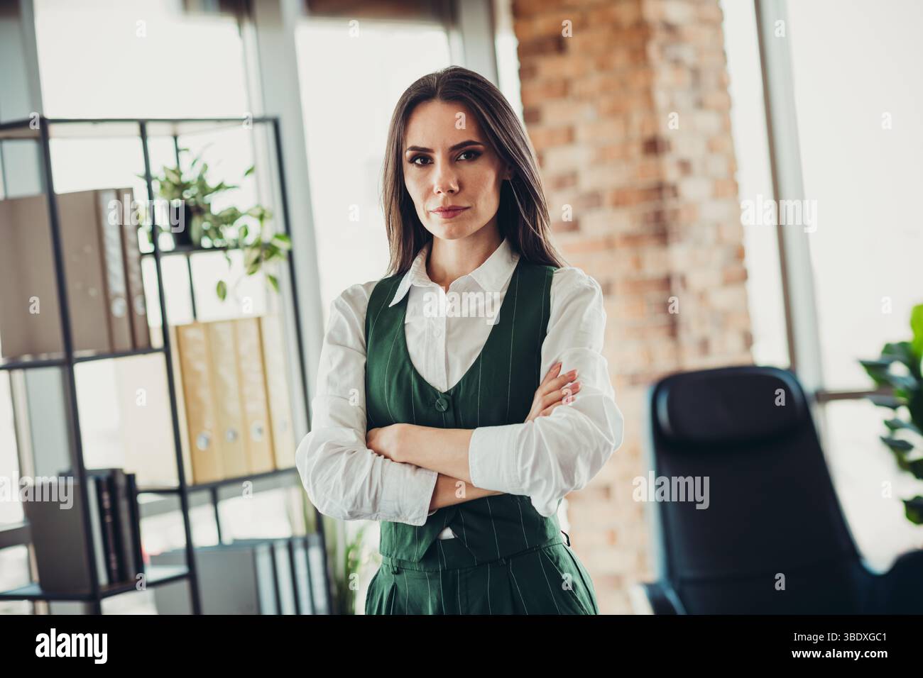 Confident businesswoman posing in elegant office environment wearing ...