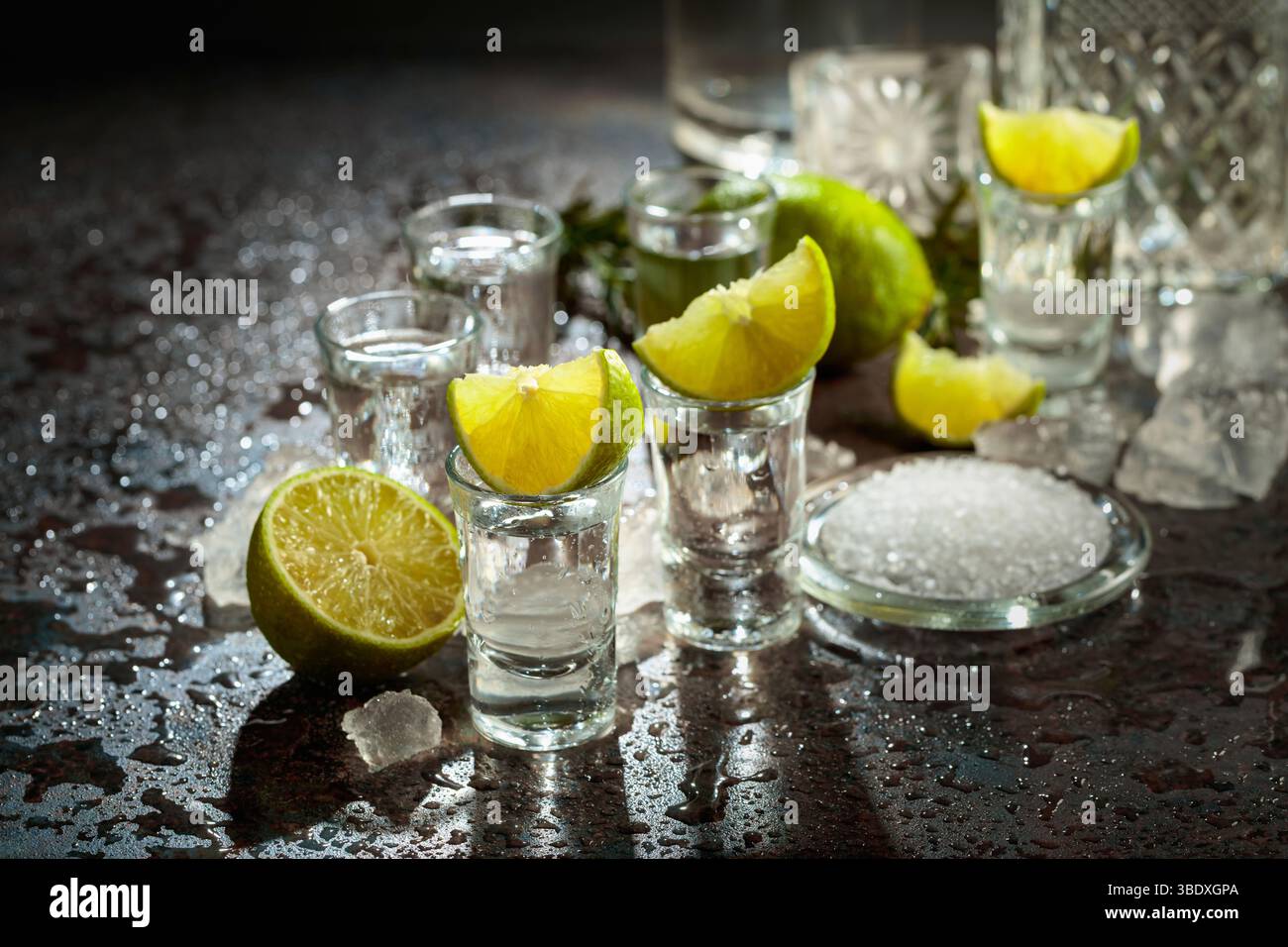 Mexican tequila with lime, sea salt, and crushed ice on a wet vintage ...