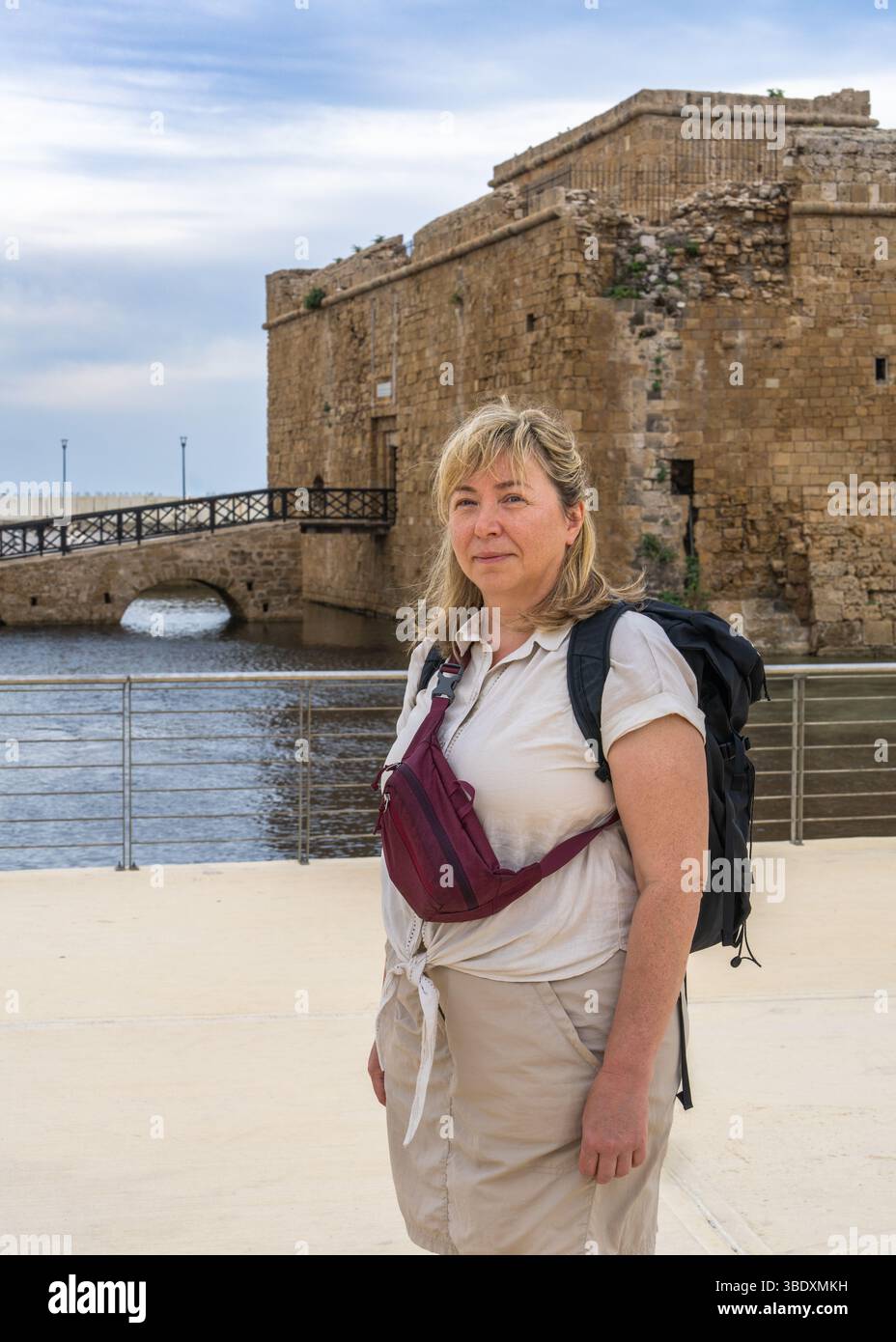 Tourist woman exploring historic castle at Paphos harbor, Cyprus ...