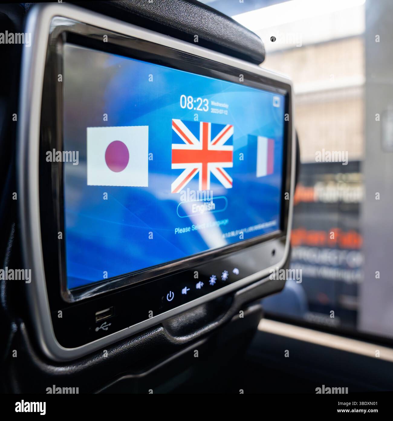 A language selection screen is displayed on a touch monitor mounted ...