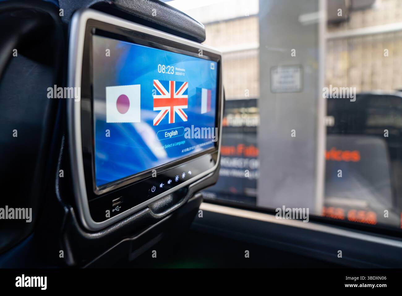 A language selection screen is displayed on a touch monitor mounted ...