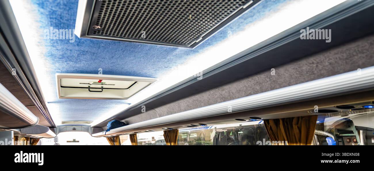 Ceiling area and overhead storage compartments of a modern tour bus are ...