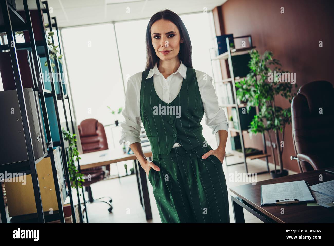 Charming business executive standing in modern office wearing formal ...