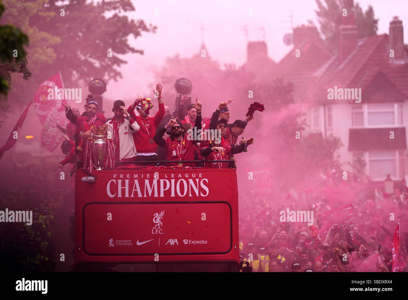 Liverpool players celebrate with the trophy on top of a bus during the Liverpool FC Premier ...