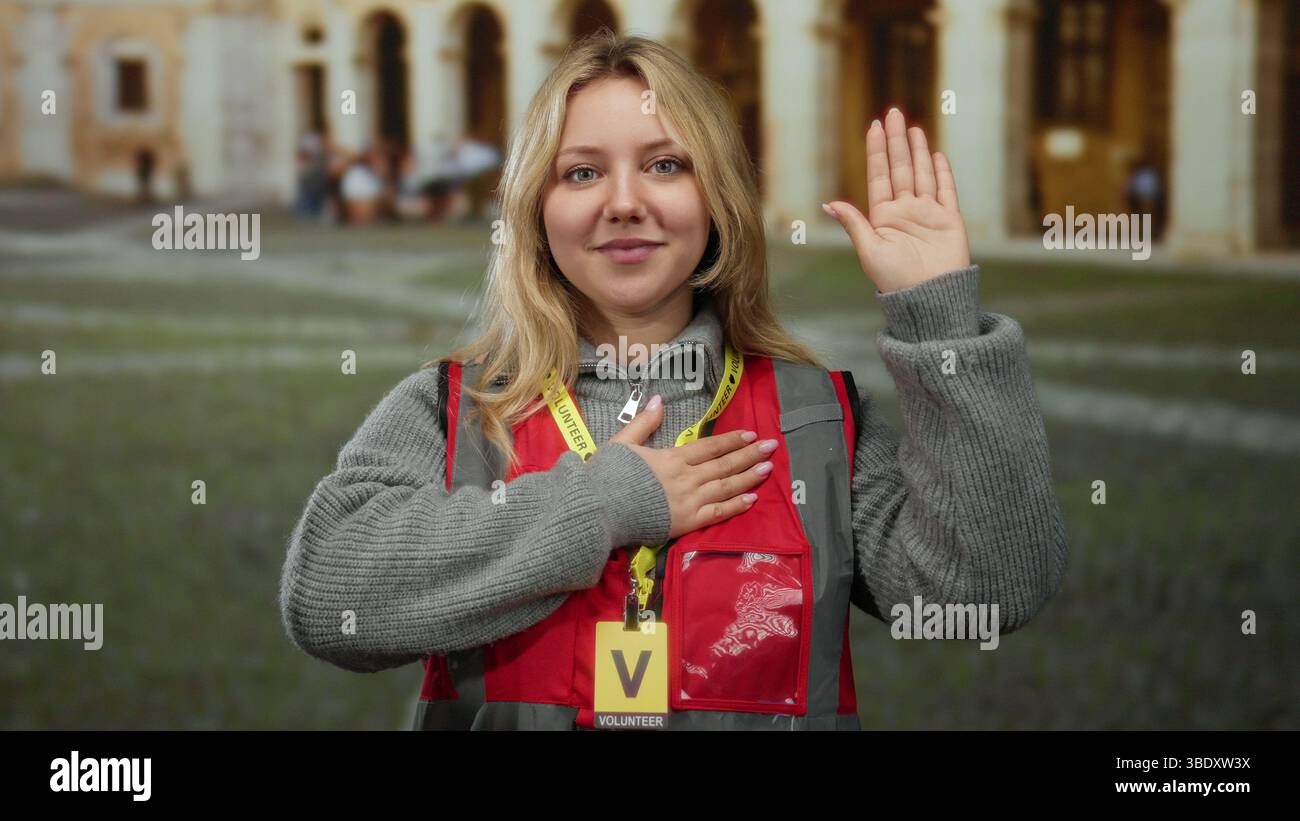 Woman volunteer performing oath gesture in an outdoor university ...