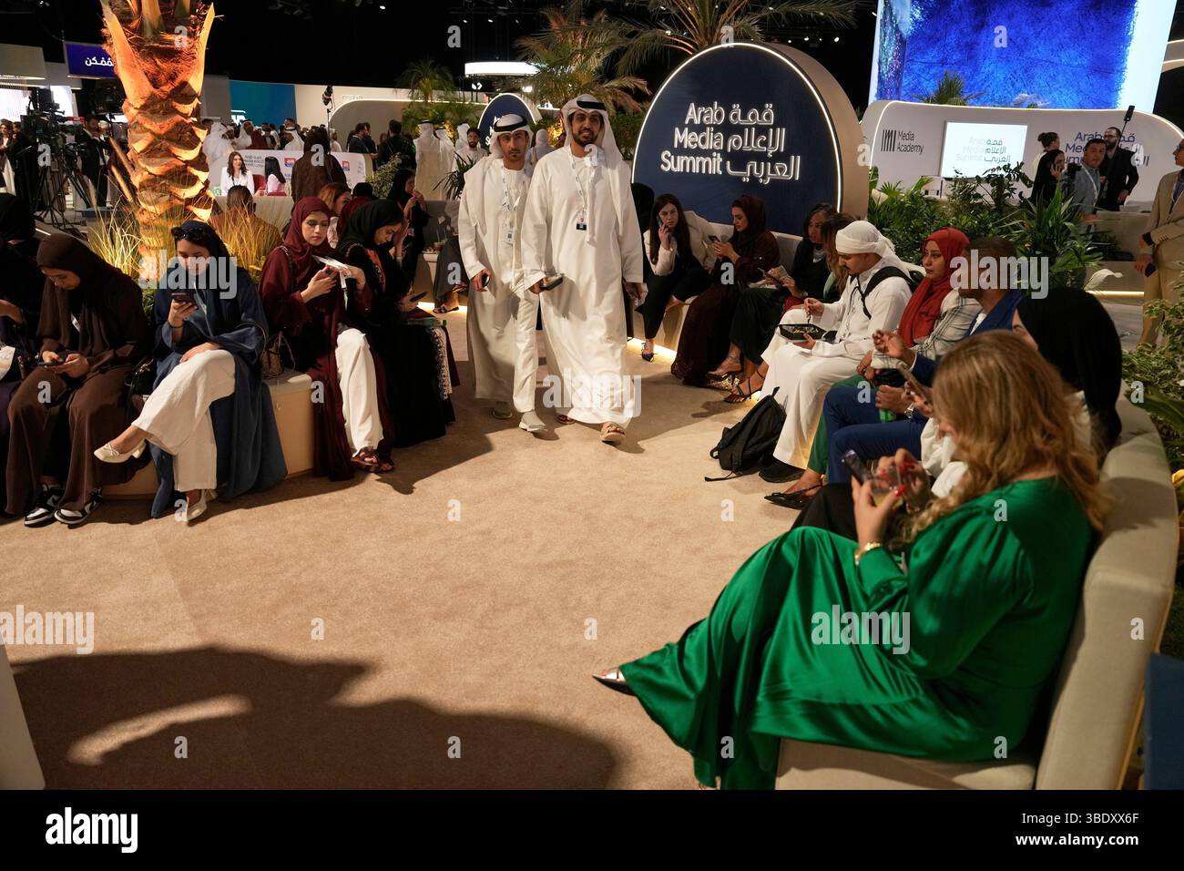 Visitors walk through the venue during the opening day of the Arab ...