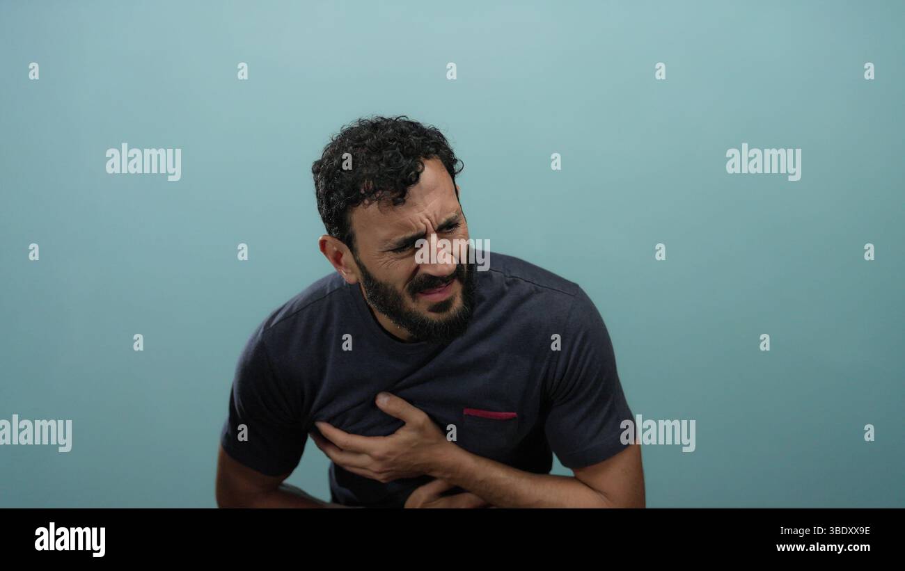 Hispanic man grasping chest hi-res stock photography and images - Alamy