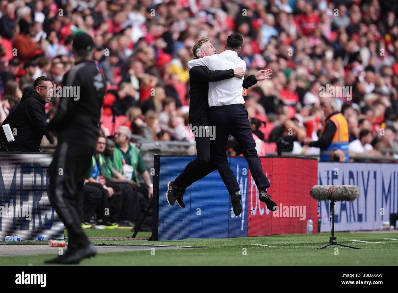 AFC Wimbledon manager Johnnie Jackson (right) celebrates his sides ...