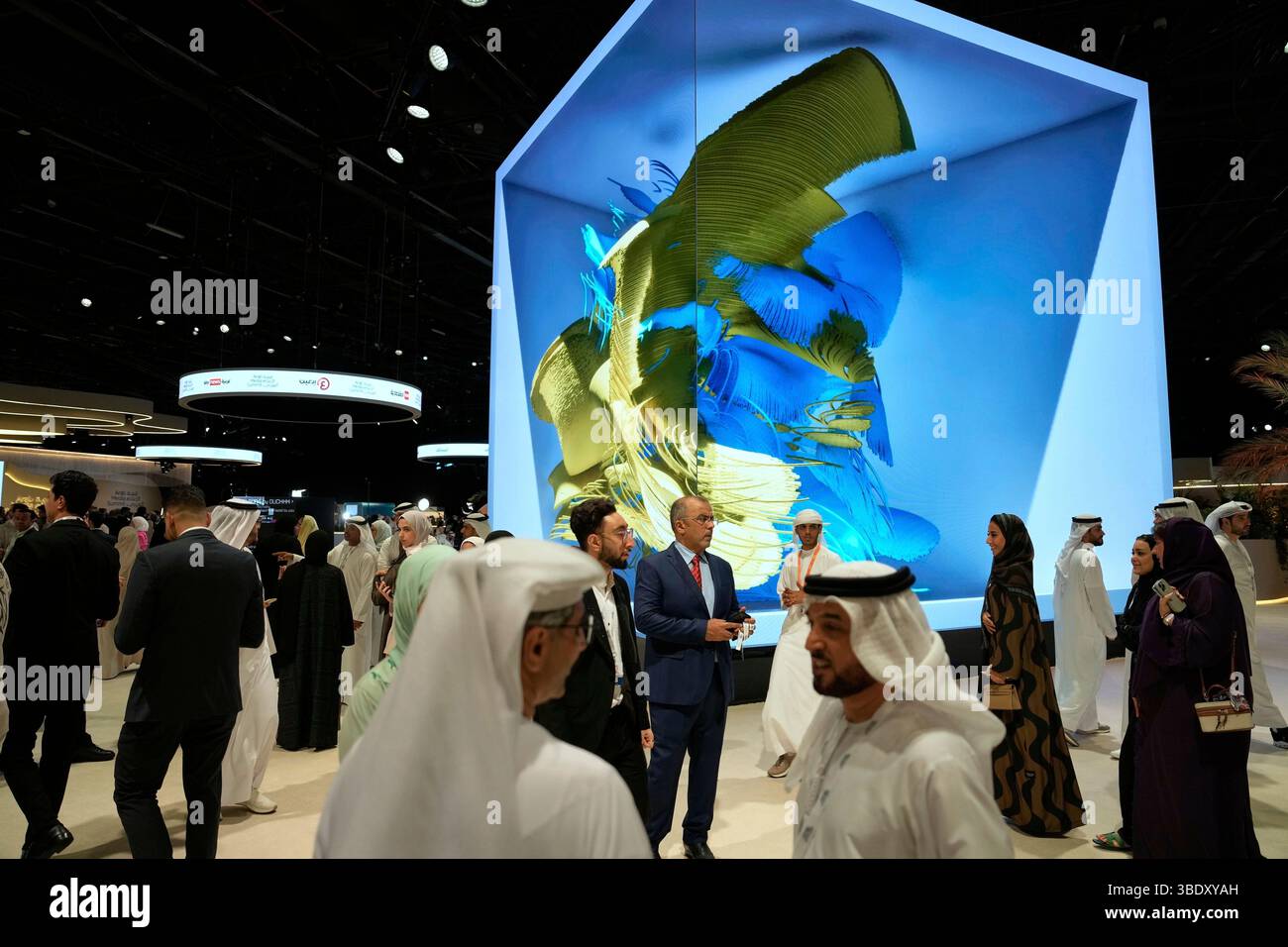 Visitors walk through the venue during the opening day of the Arab ...