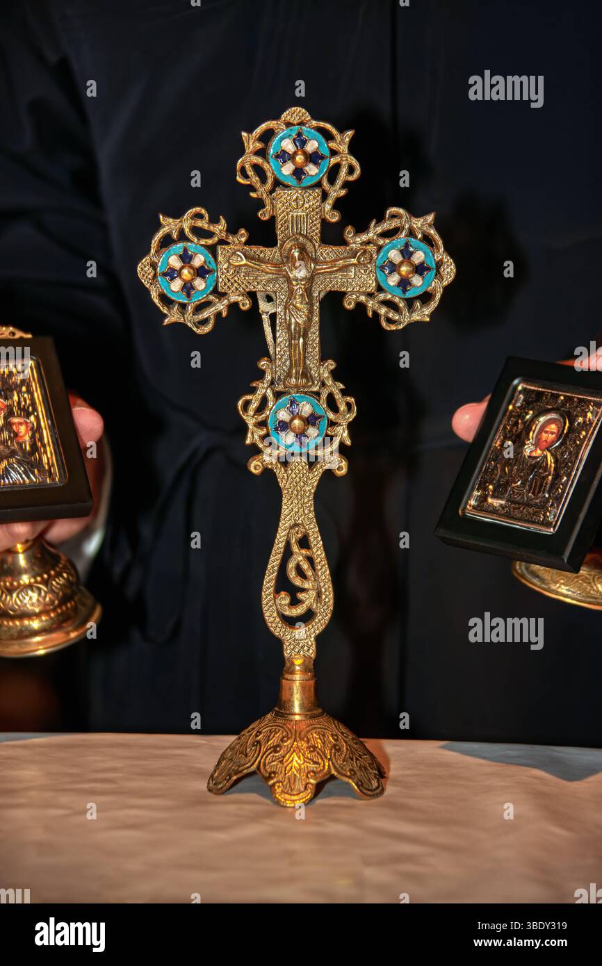 Christian Greek orthodox cross crucifix , held by a priest and icons ...