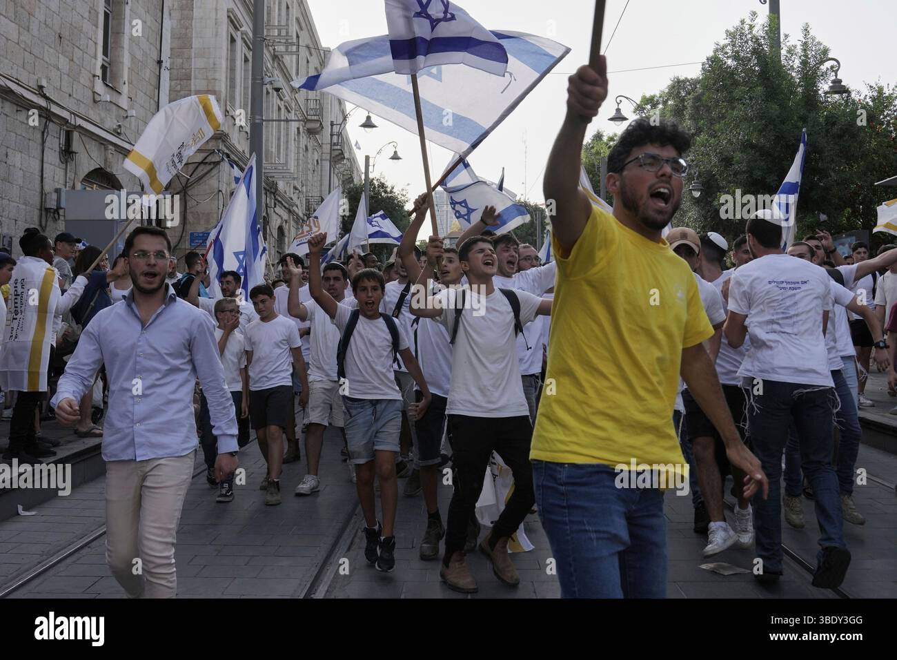 Israelis wave national flags during a march marking Jerusalem Day, an ...