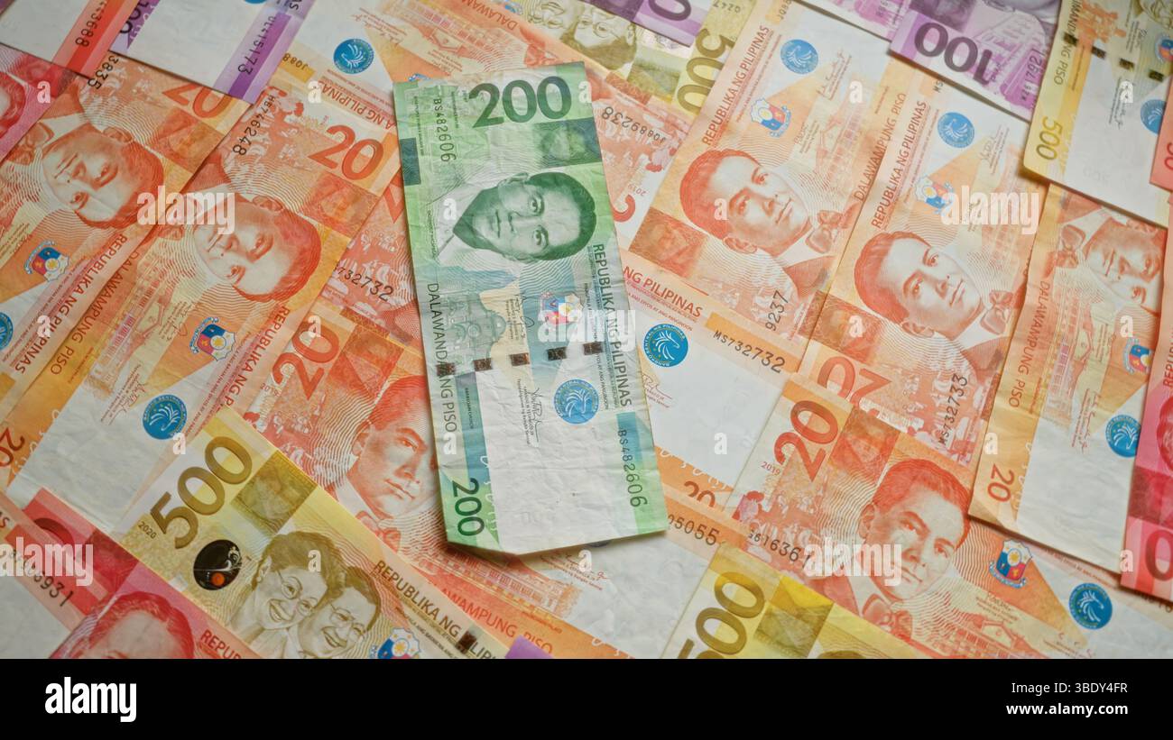 Philippine banknotes scattered, showcasing various denominations of ...