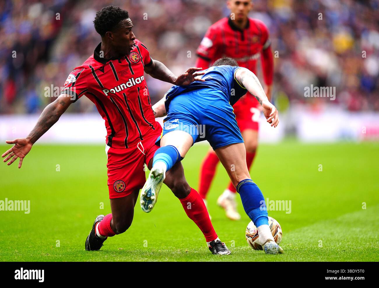 Walsall's Liam Gordon (left) and AFC Wimbledon's James Tilley battle ...