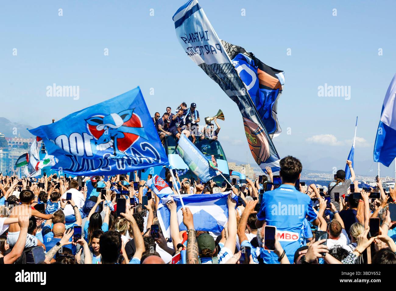 The crowd cheers as Napoli players celebrate winning their fourth Serie ...