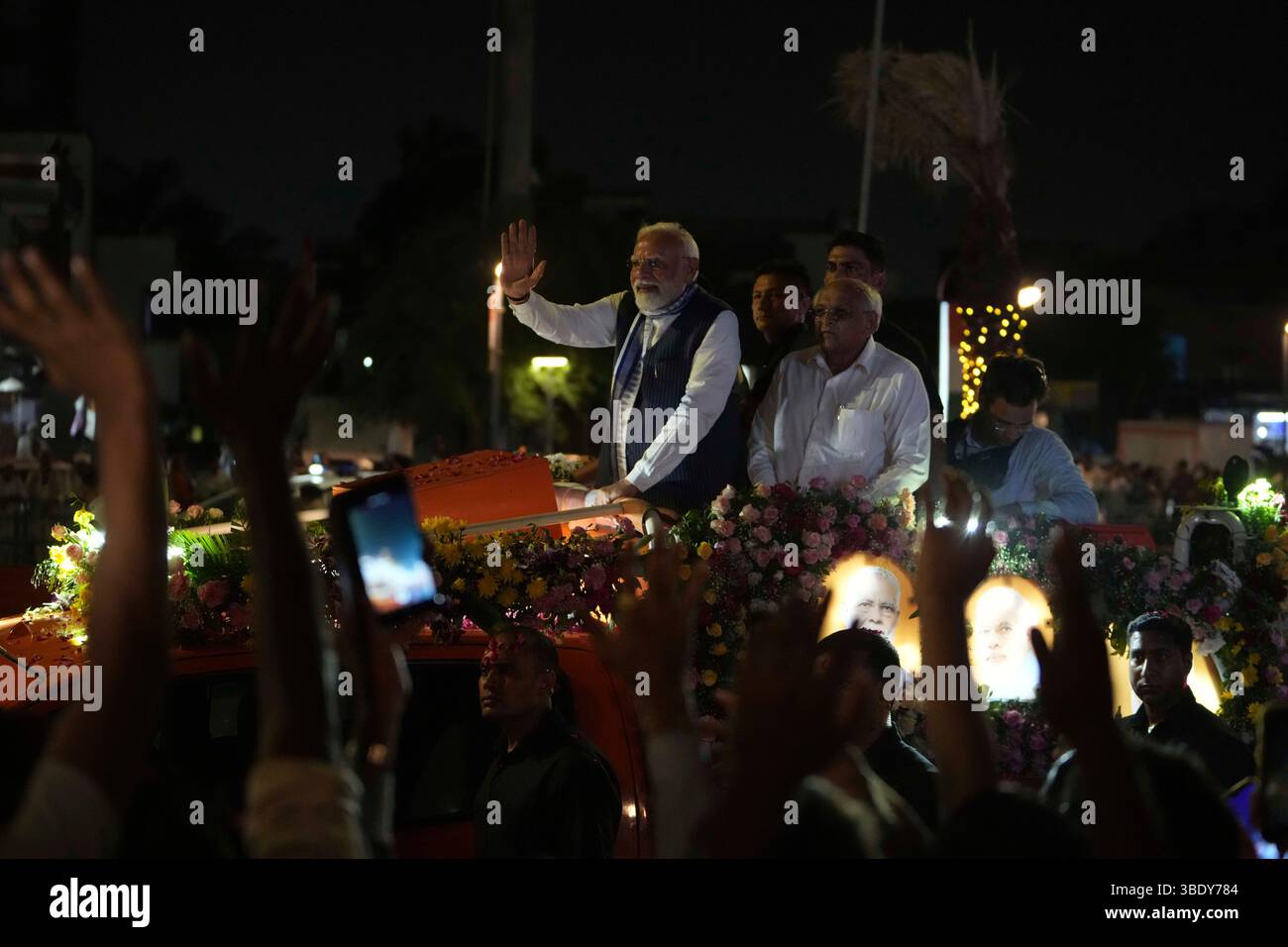 Indian Prime Minister Narendra Modi waves from a vehicle during a road ...