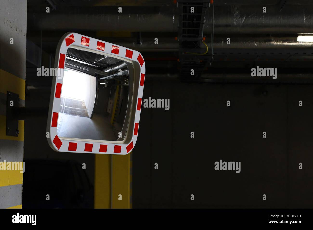 Square safety mirror hanging on the pillar of underground parking Stock ...