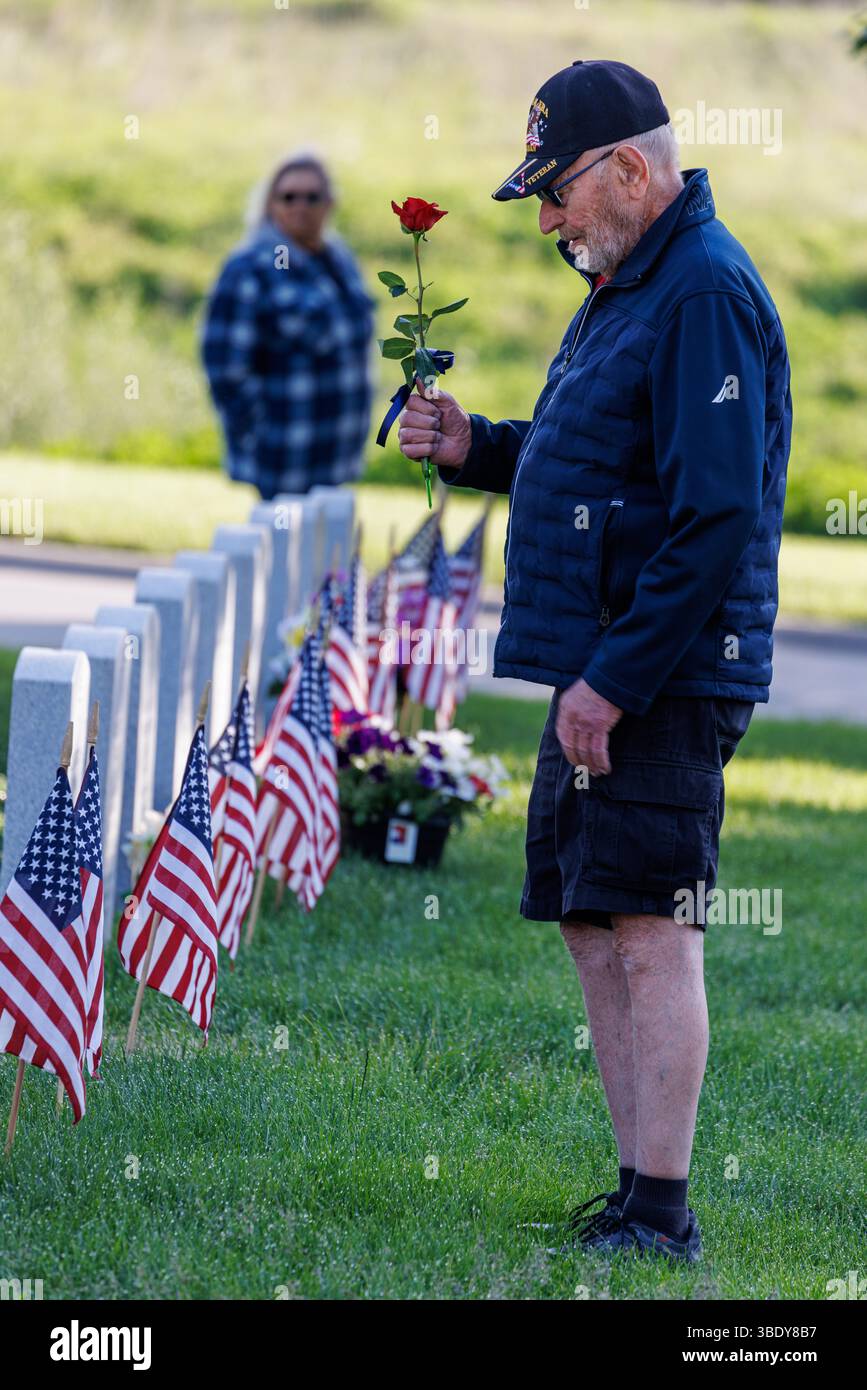 Van Meter, Iowa, USA. 26th May, 2025. A visitor holds a rose before ...
