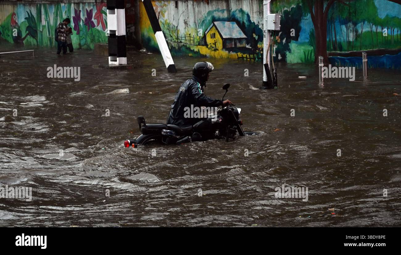 MUMBAI, INDIA - MAY 26: Vehicles wade through waterlogged road at Gandhi Market in the Sion area ...