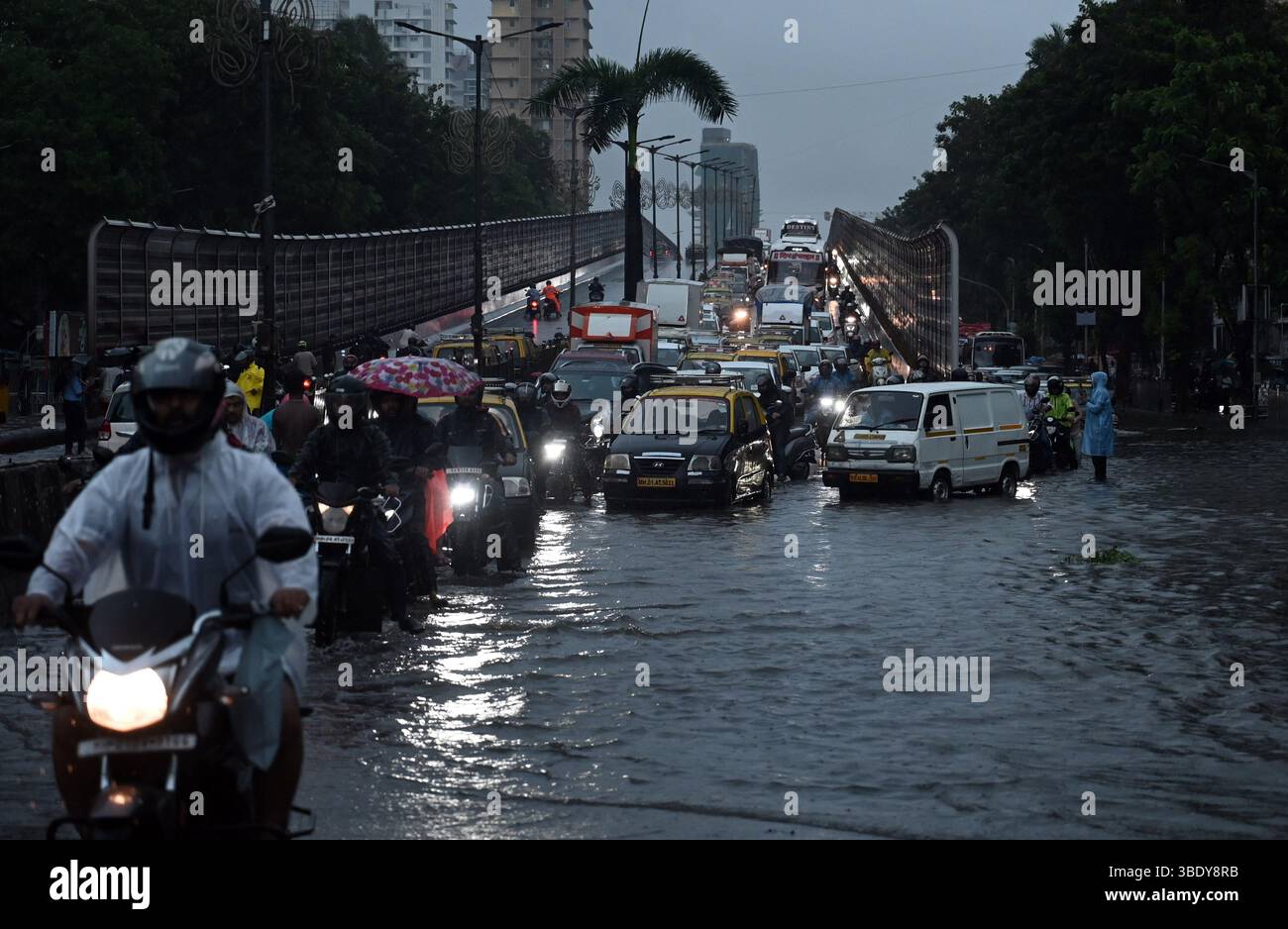 MUMBAI, INDIA - MAY 26: Vehicles wade through waterlogged road at Gandhi Market in the Sion area ...