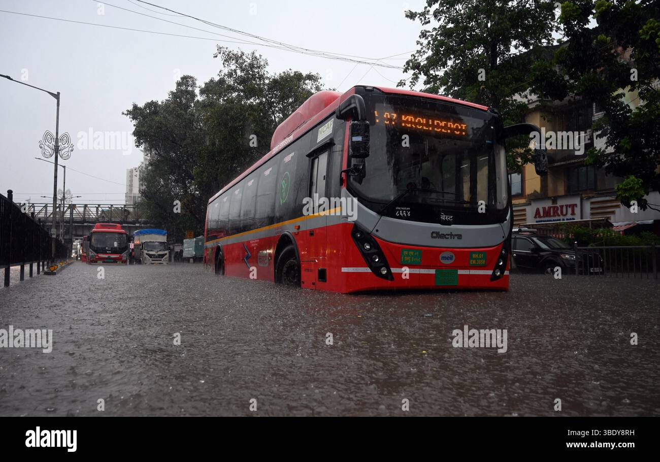 MUMBAI, INDIA - MAY 26: Vehicles wade through waterlogged road at Gandhi Market in the Sion area ...