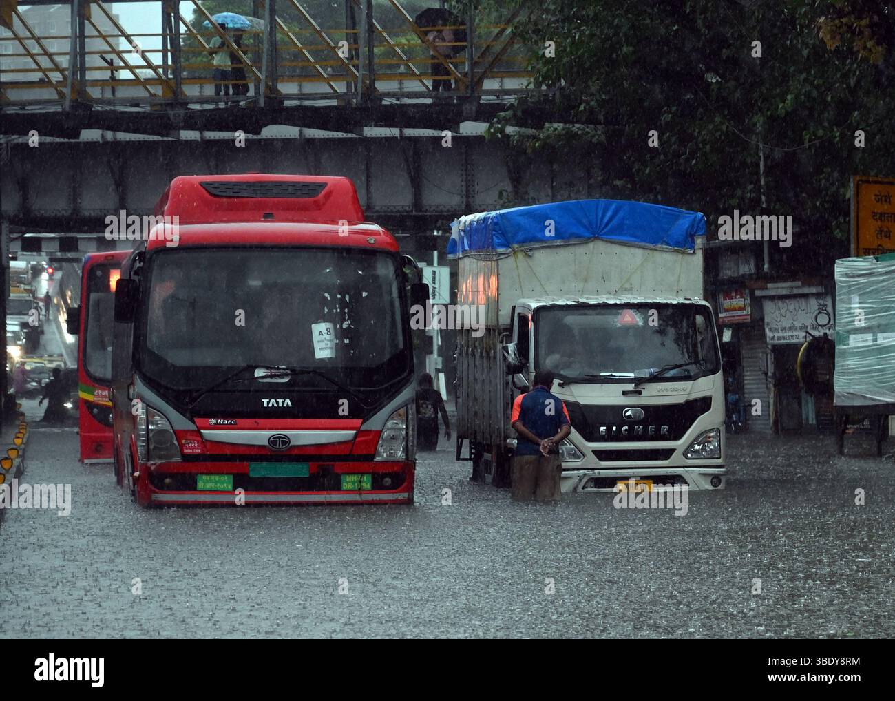 MUMBAI, INDIA - MAY 26: Vehicles wade through waterlogged road at Gandhi Market in the Sion area ...