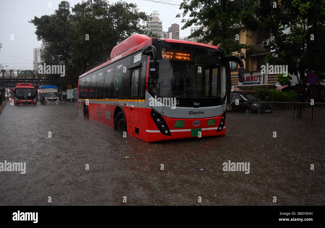 MUMBAI, INDIA - MAY 26: Vehicles wade through waterlogged road at Gandhi Market in the Sion area ...