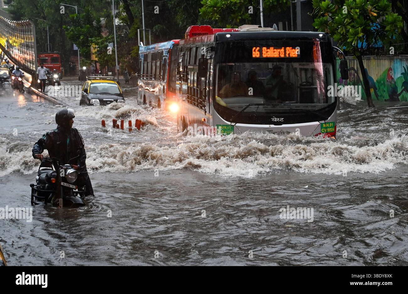 MUMBAI, INDIA - MAY 26: Vehicles wade through waterlogged road at Gandhi Market in the Sion area ...