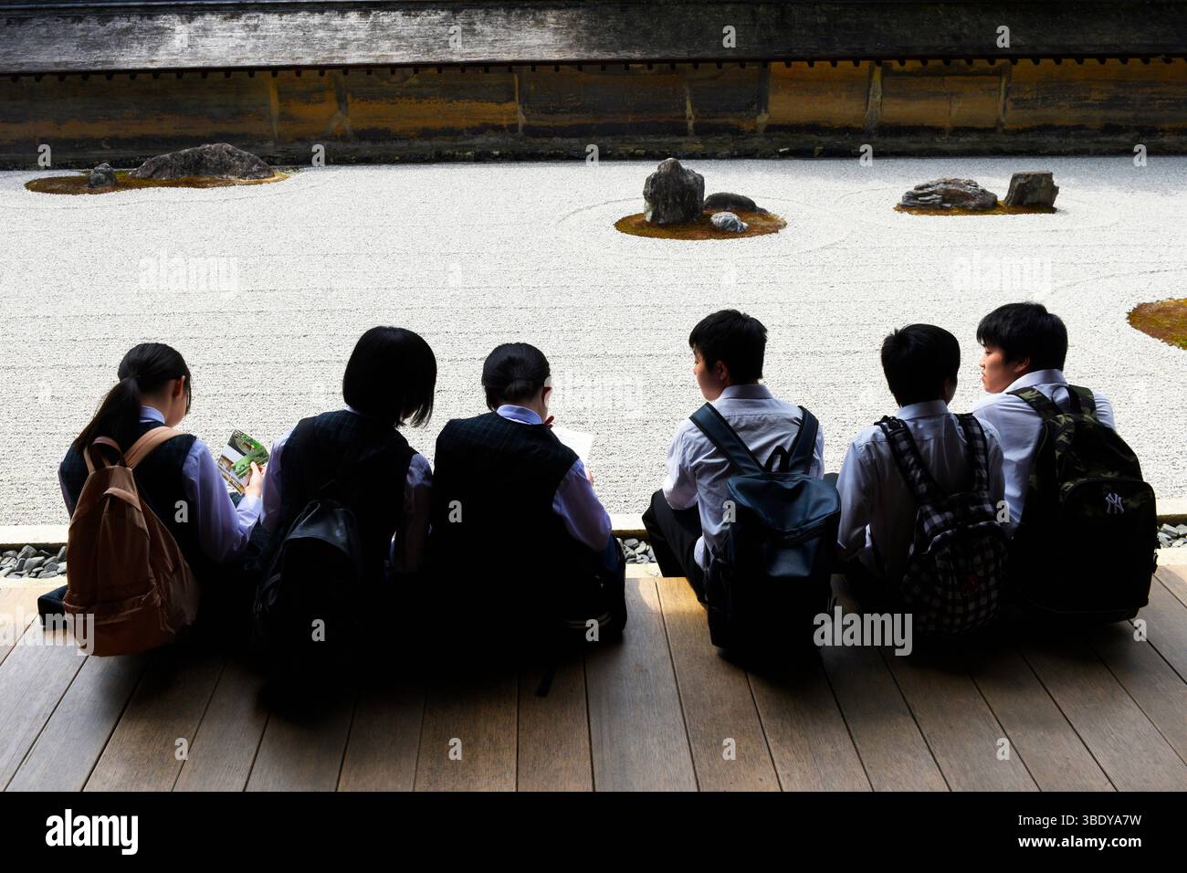 Japanese students observe Ryoan-ji temples,famous rock garden from the ...