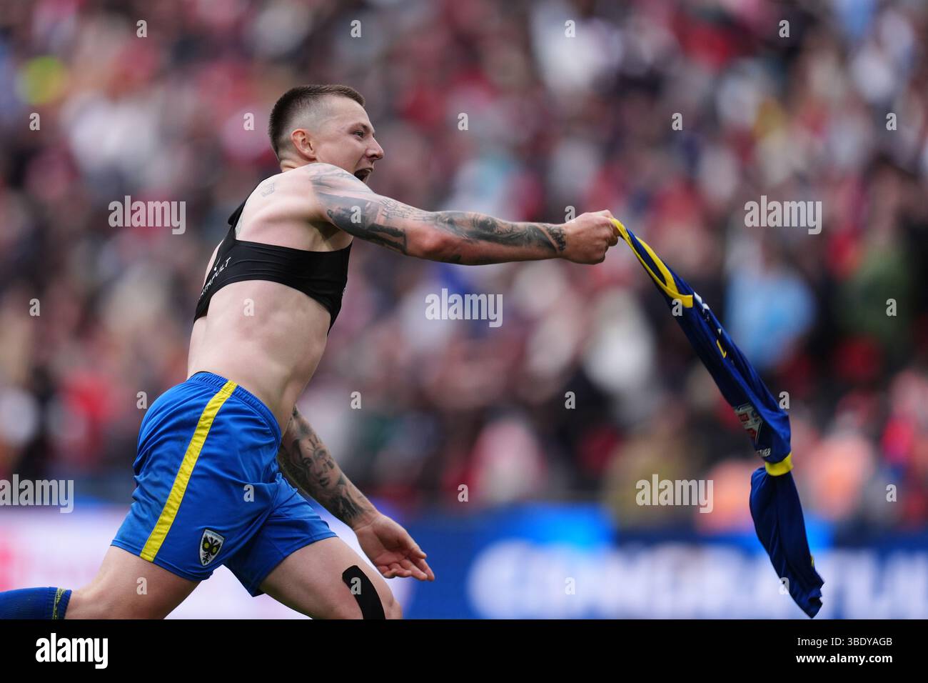 AFC Wimbledon's James Tilley celebrates promotion after the final ...