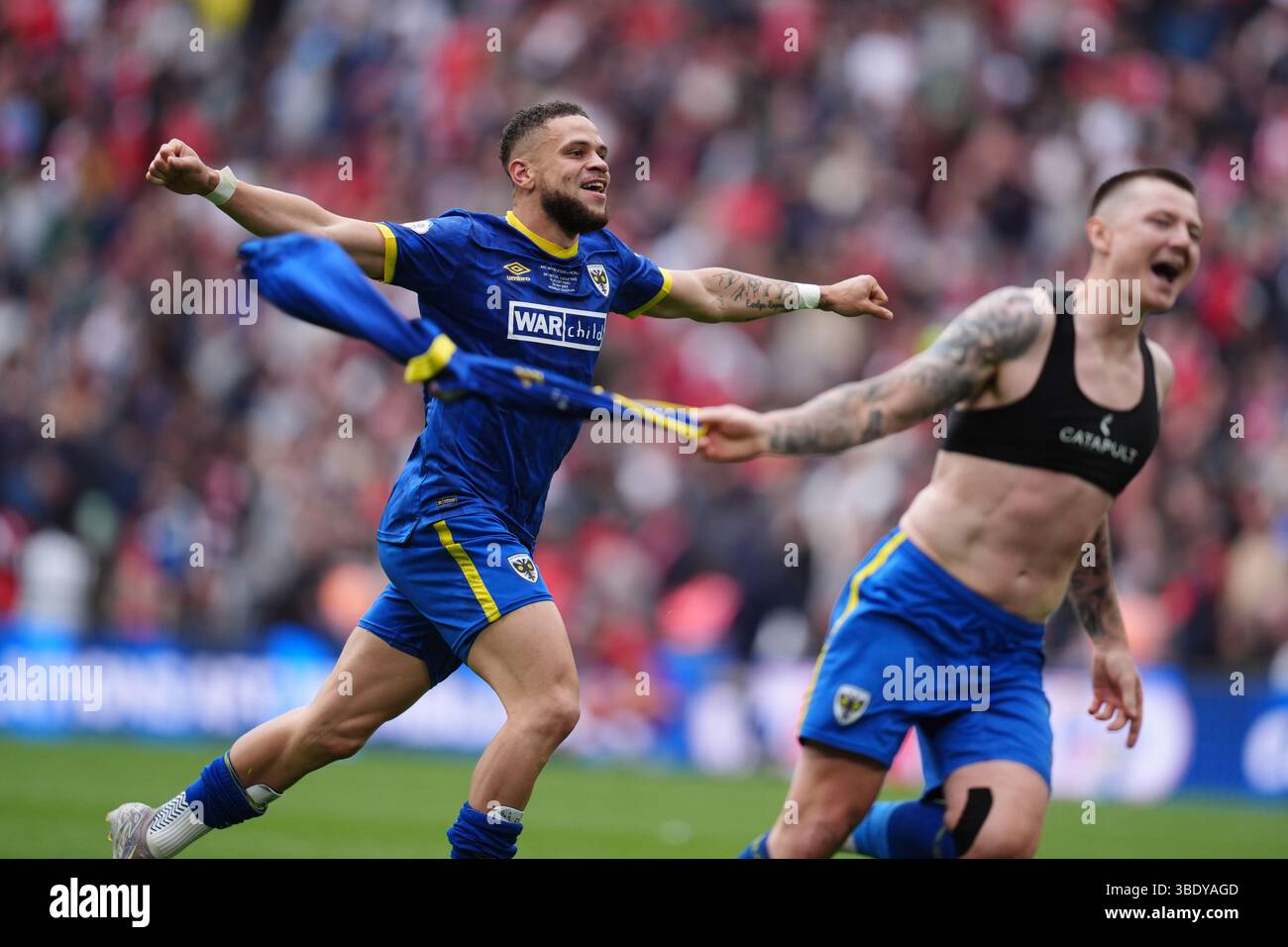 AFC Wimbledon's James Tilley (right) AFC Wimbledon's Marcus Browne (left) celebrate promotion ...