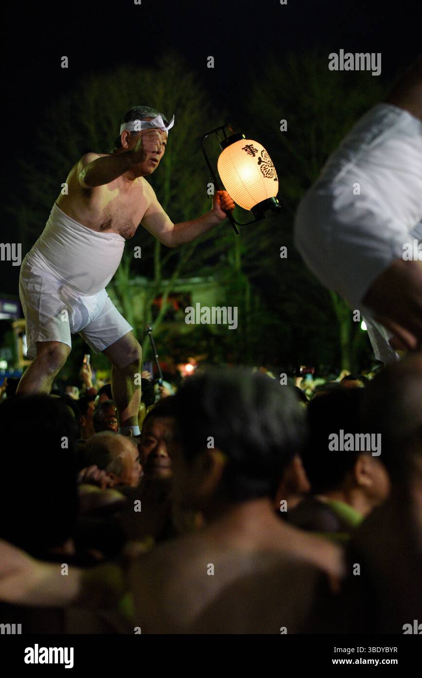 Men in loincloths performs a ritual for good luck to residents during ...