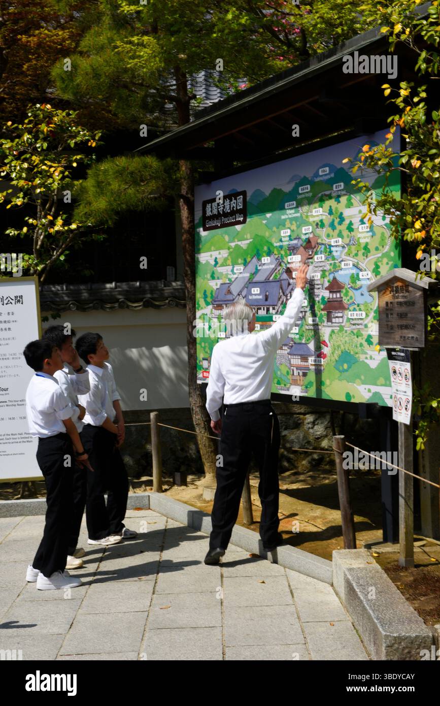 A japanese teacher with school children looking map at Ginkaku-ji ...