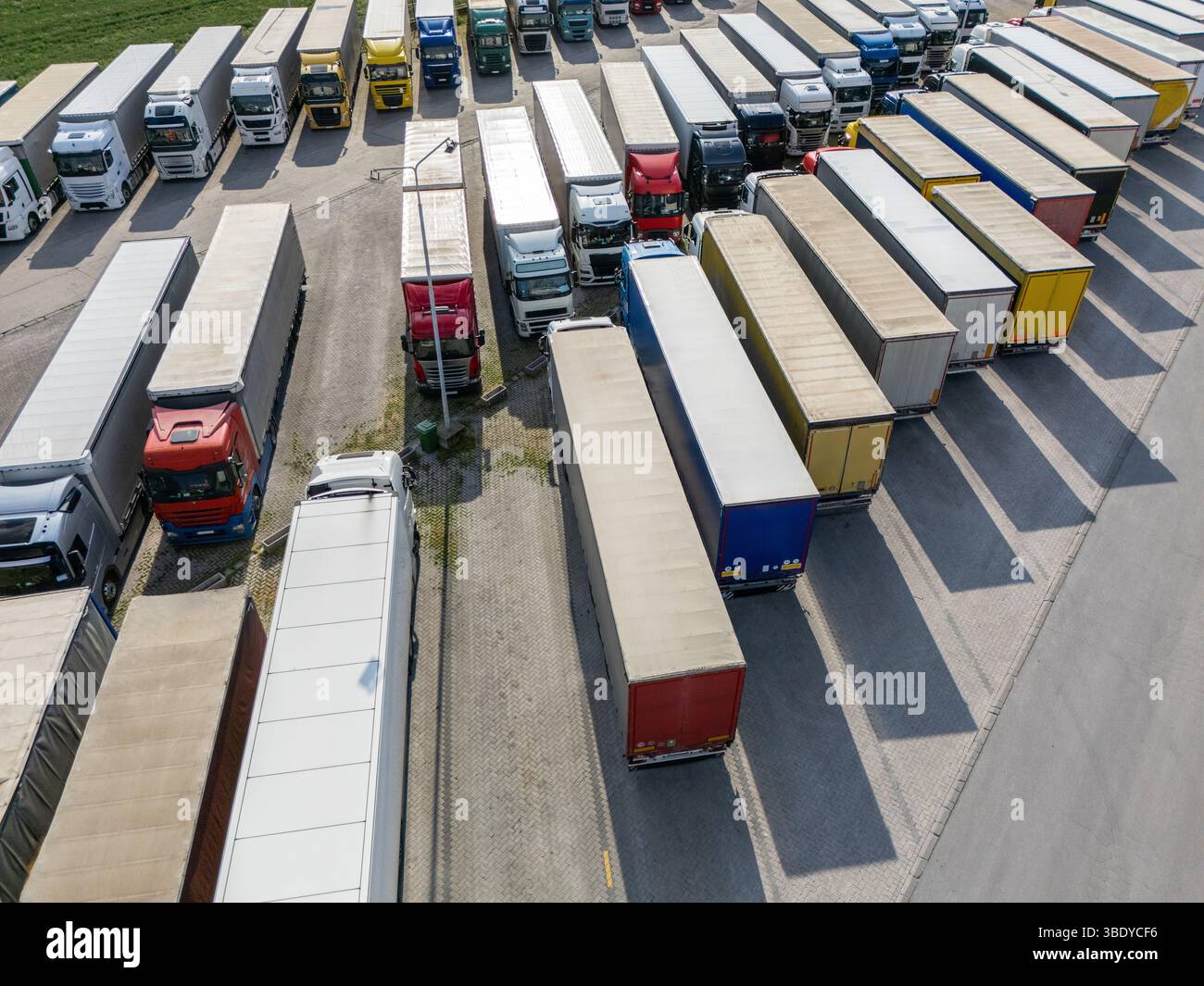 Aerial view of a large truck parking lot at a logistics hub, with ...
