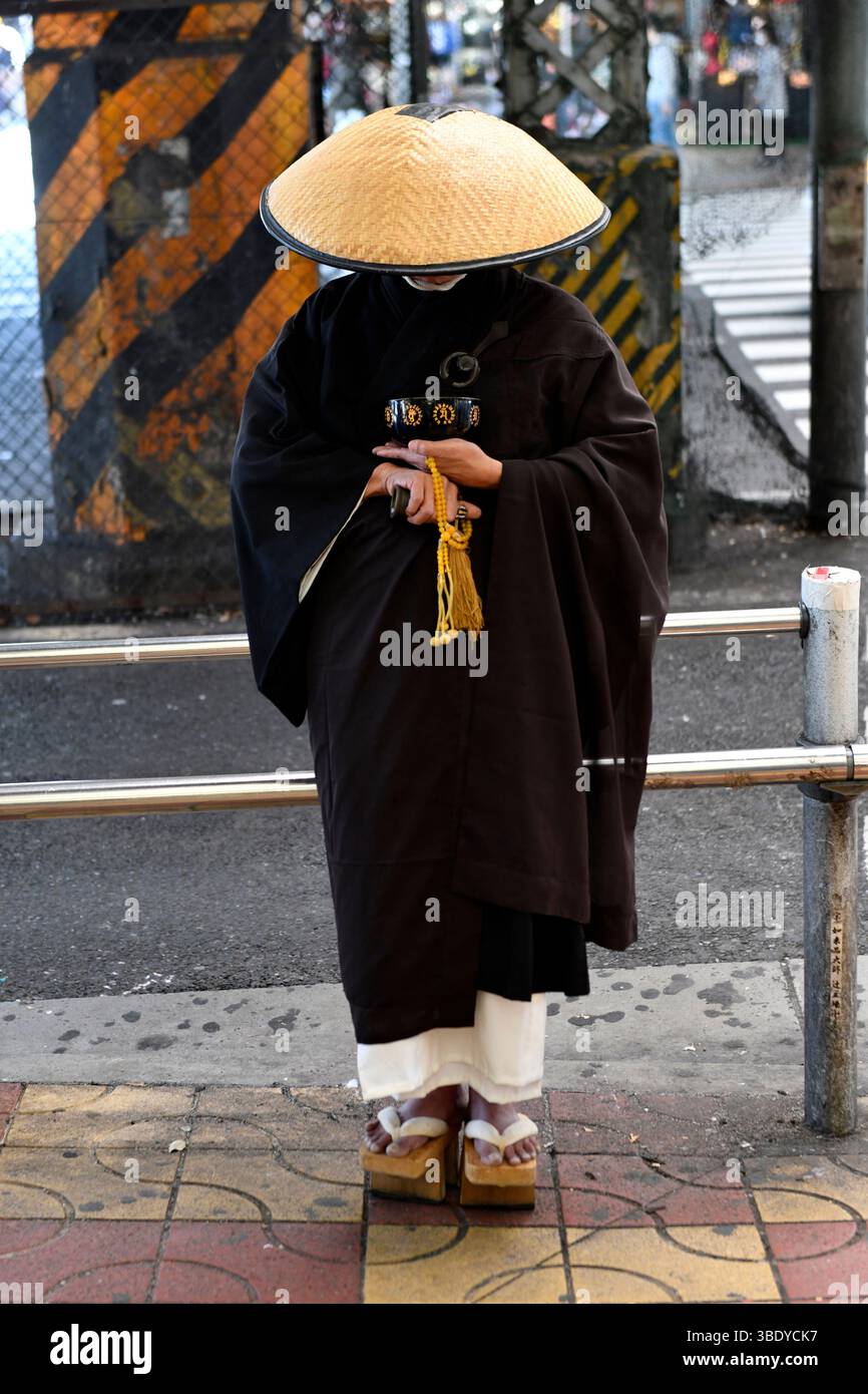 Shinto monk in traditional dress collecting alms in Osaka,Japan,Asia ...