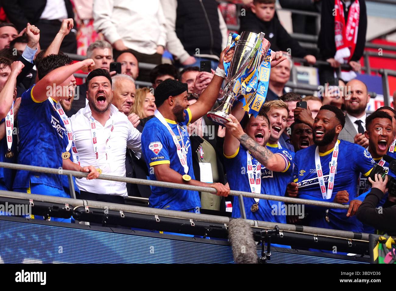 AFC Wimbledon's Ryan Johnson and Jack Reeves lift the trophy with team ...