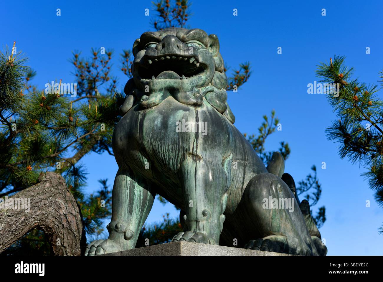 A stone lion statue stands guard at the Itsukushima Shrine,Miyajima ...