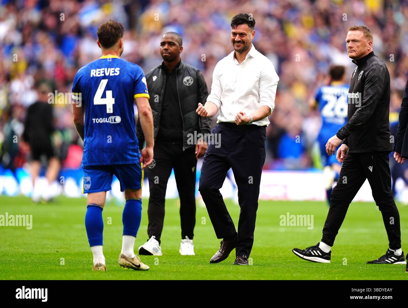 AFC Wimbledon manager Johnnie Jackson (second right) celebrates victory ...